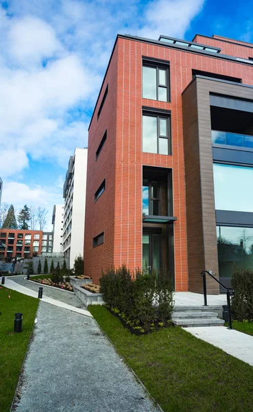 Modern Red Brick Apartment Complex with solid rock fence wall. Home ...