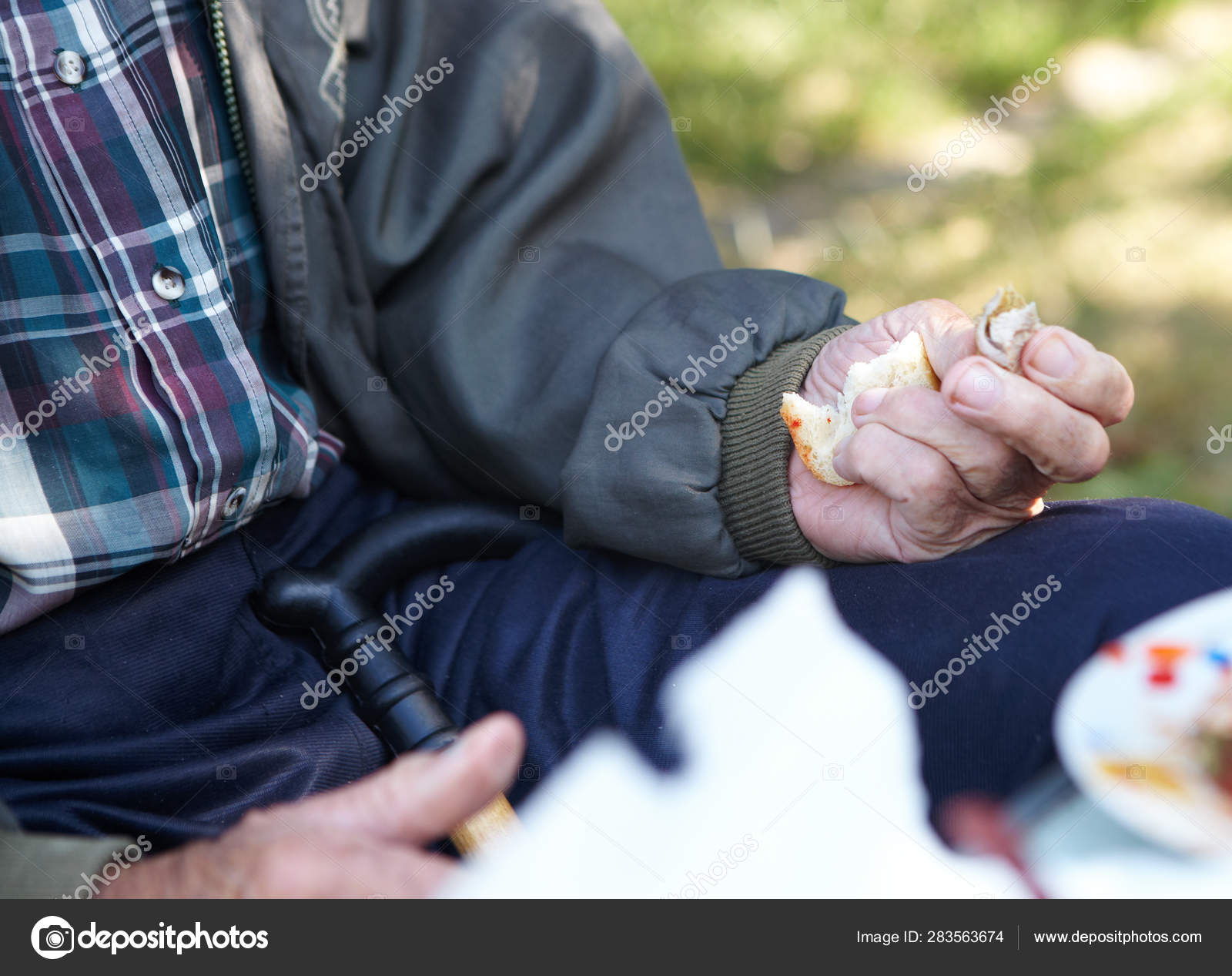Elderly poor man eating bread — Stock Photo © petrkurgan #283563674