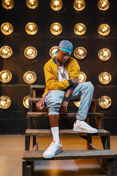 Black Rapper Cap Sitting Steps Singer Stage Spotlights Background Rap ...