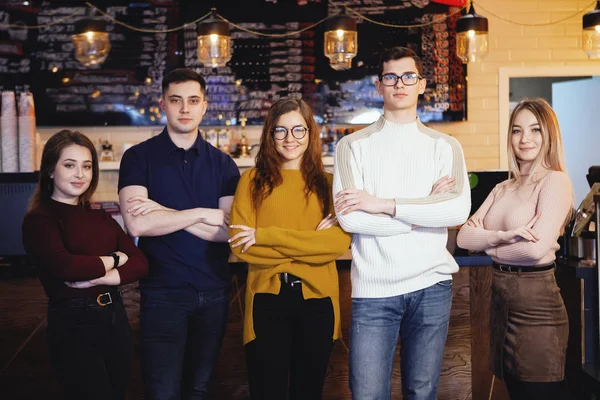 Group of five young men guys and girls are happy to pose for the ...