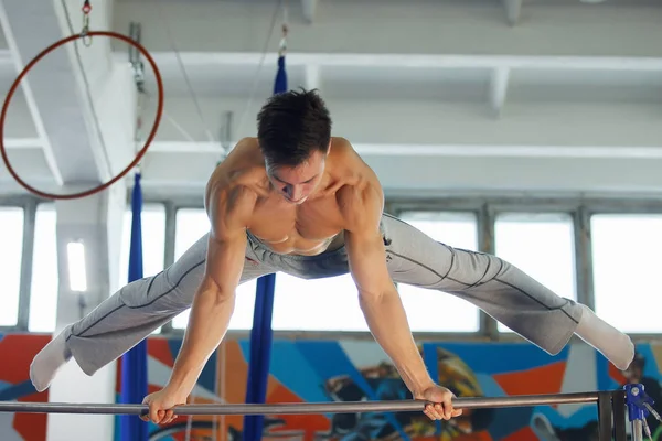 Man making exercises on crossbar. Stock Photo by ©vorobevaola 268566550