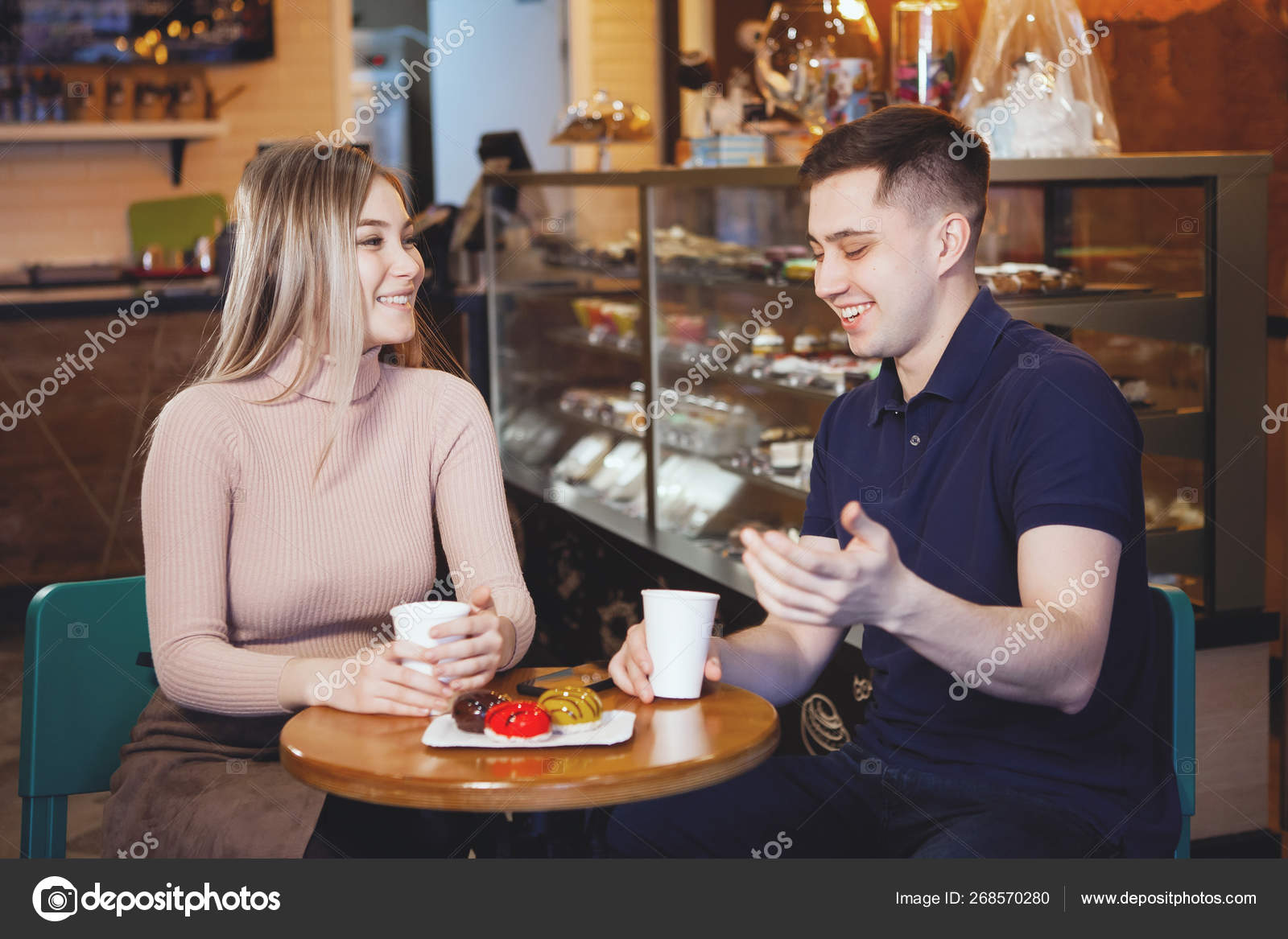 Two cute young boy and girl in a cafe. Stock Photo by ©vorobevaola ...
