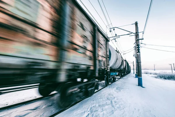 The freight train is moving along a snow-covered railway. - Stock Image ...