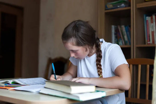 High school student doing homework at home. - Stock Image - Everypixel