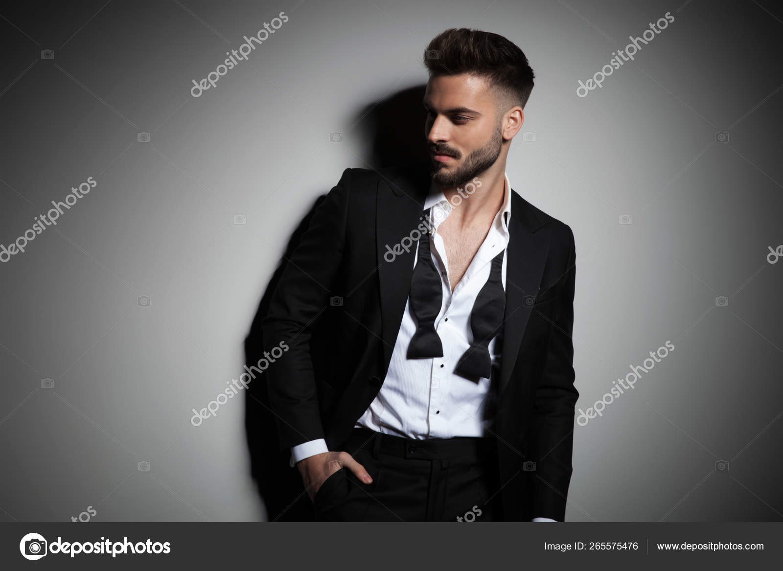 Handsome man in tuxedo with undone collar holding hand in pocket Stock ...