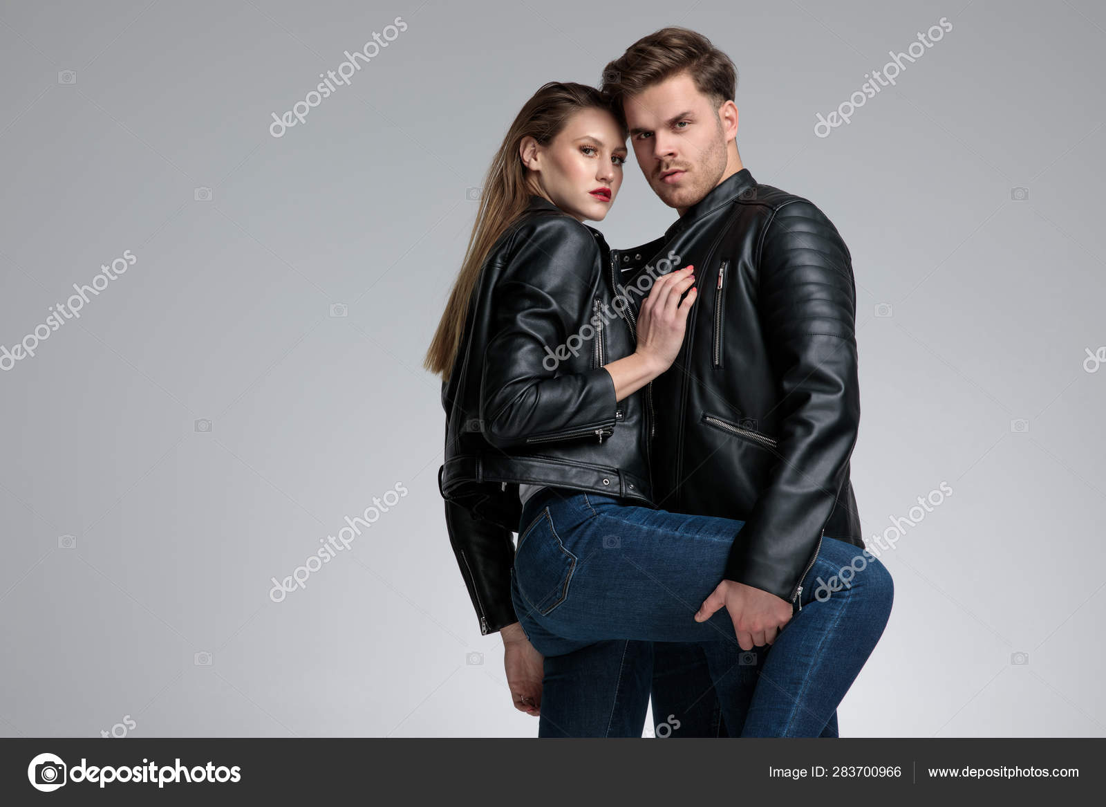 Tough young man embracing and protecting his girlfriend Stock Photo by ...