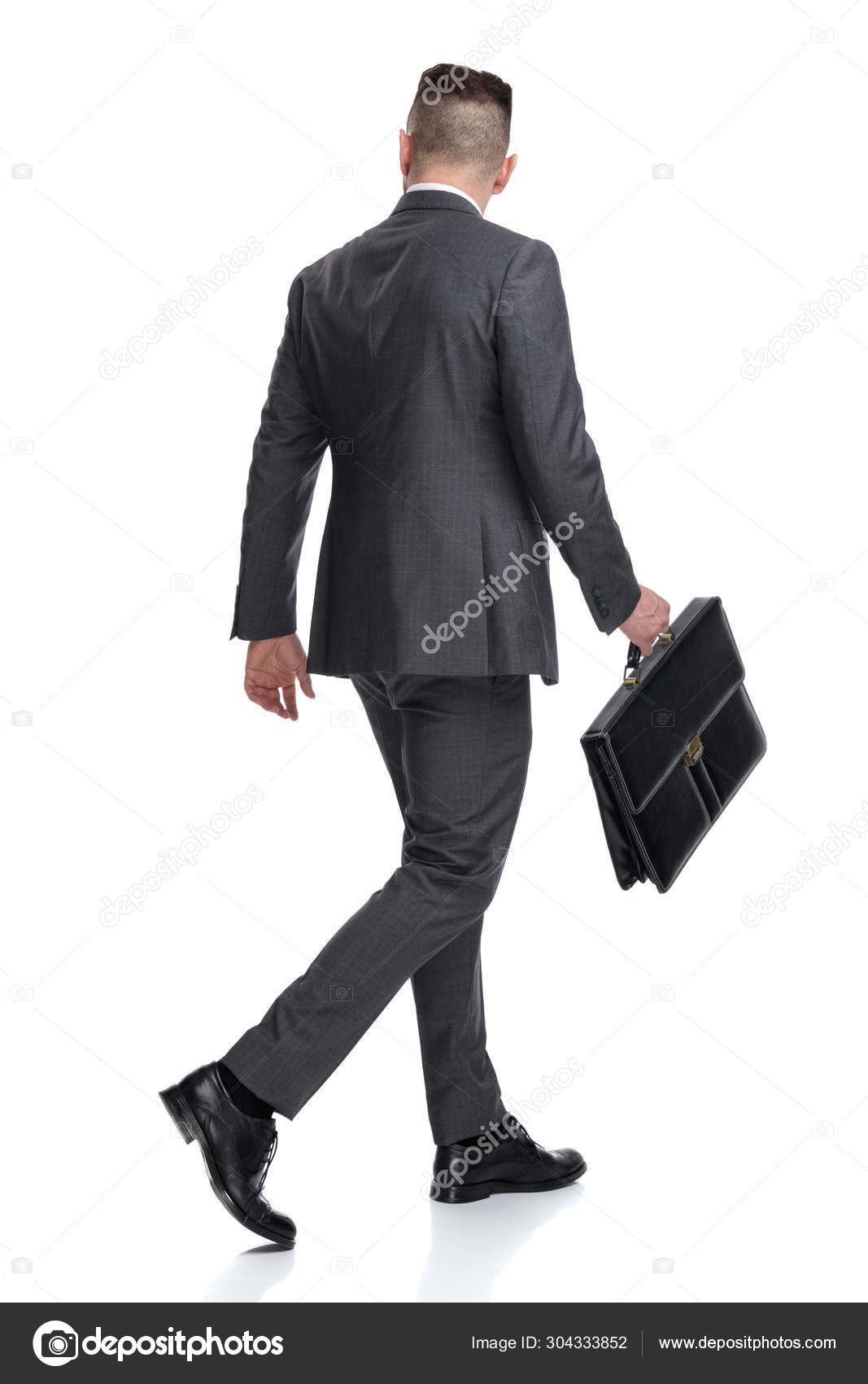 Back view of a businessman walking and looking to side Stock Photo by ...