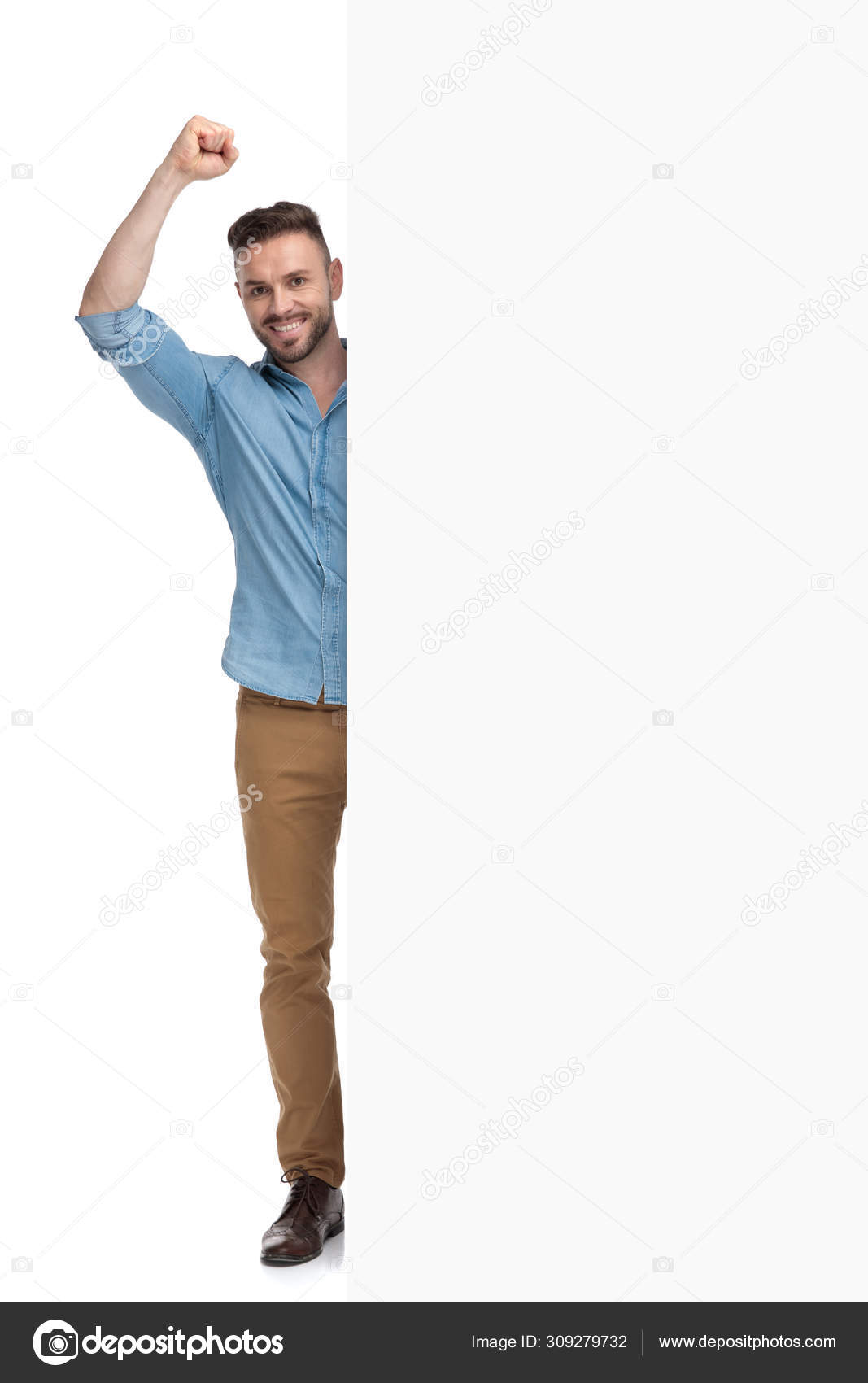 Casual man standing behind billboard with fist up — Stock Photo ...