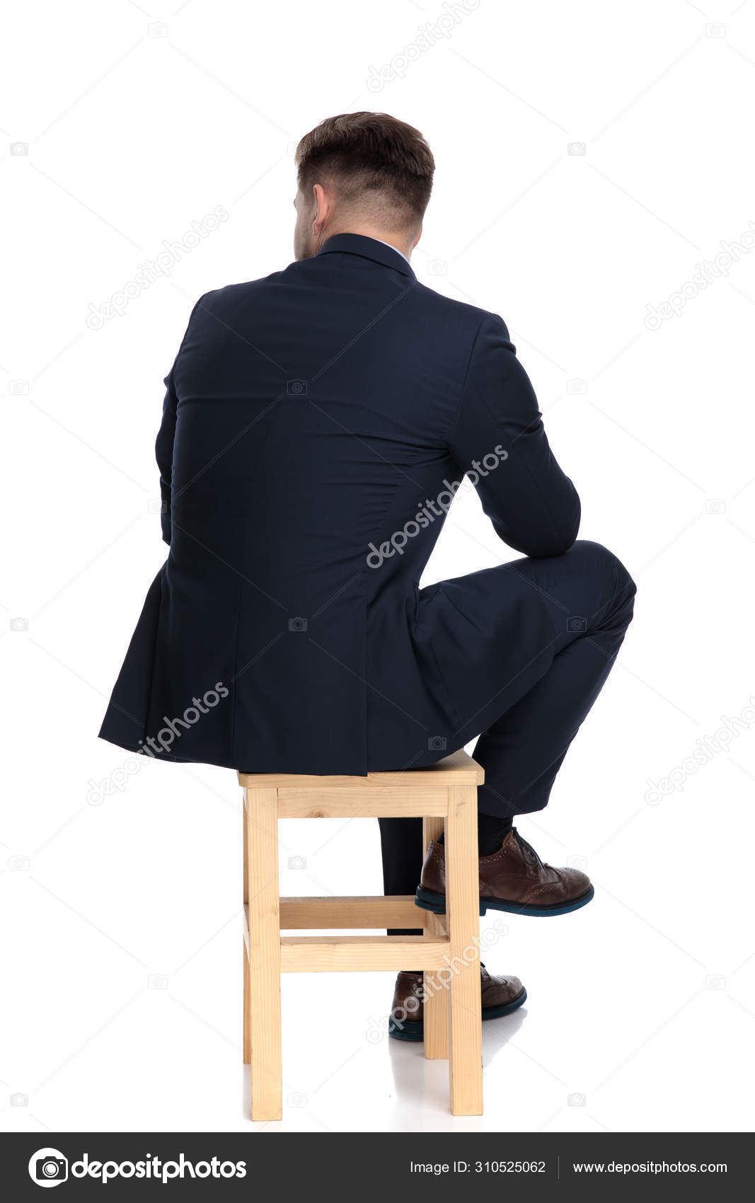 Back view of young businessman sitting on wooden chair — Stock Photo ...
