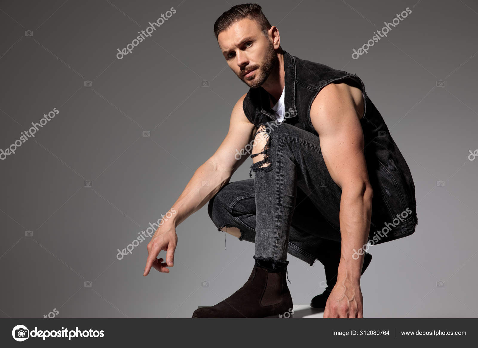 Tough man pointing down and squatting ⬇ Stock Photo, Image by ...