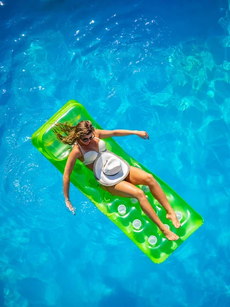 A girl is relaxing in a swimming pool Stock Photo by ©netfalls 30297425