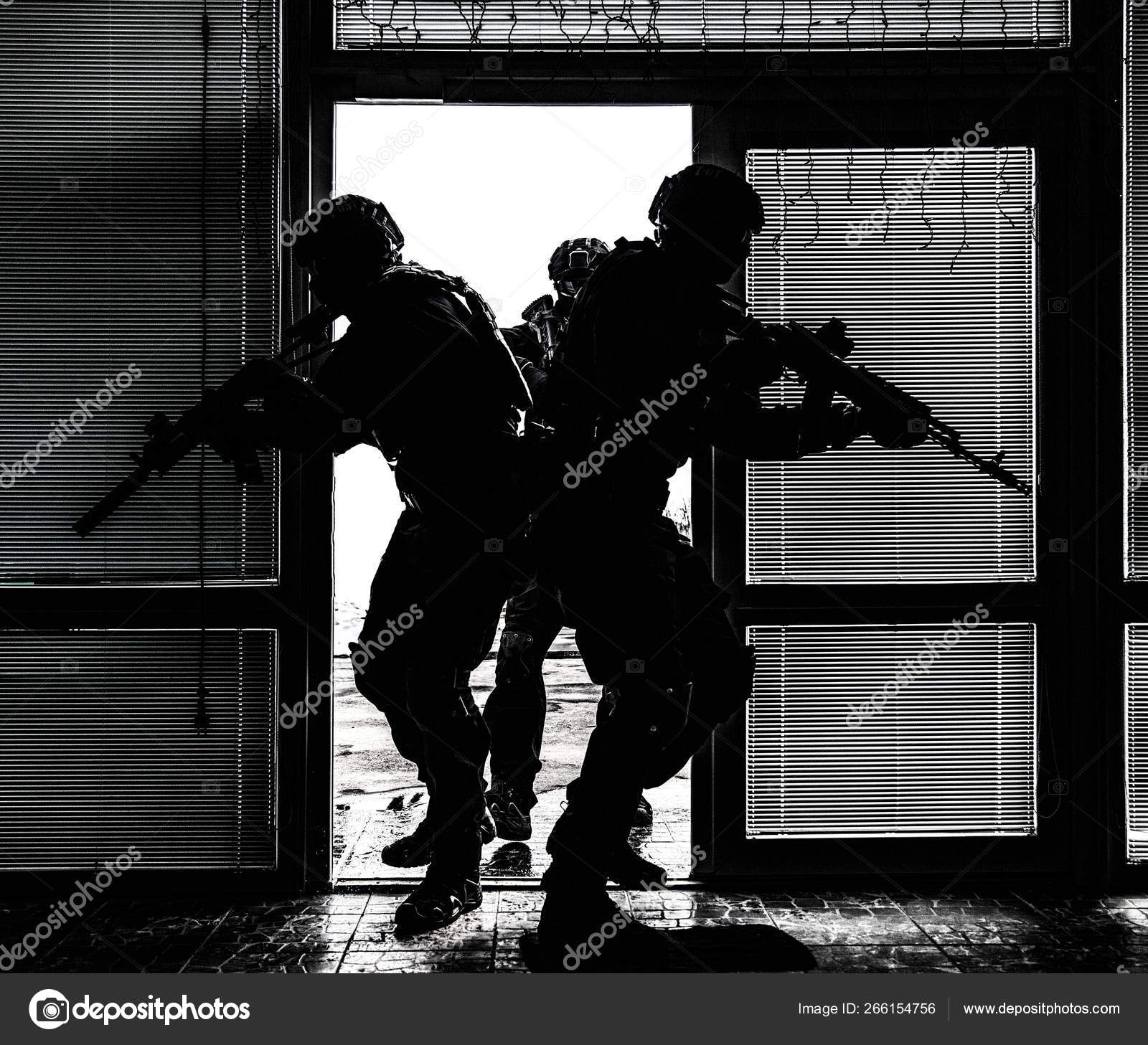 SWAT team breaching door and storming apartments — Stock Photo ...