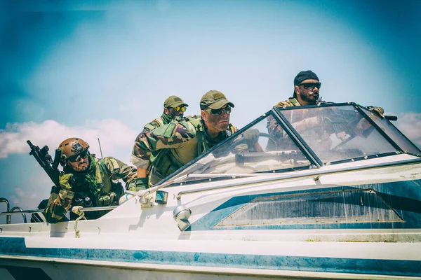 Navy SEALs team fighters rushing on speed boat - Stock Image - Everypixel