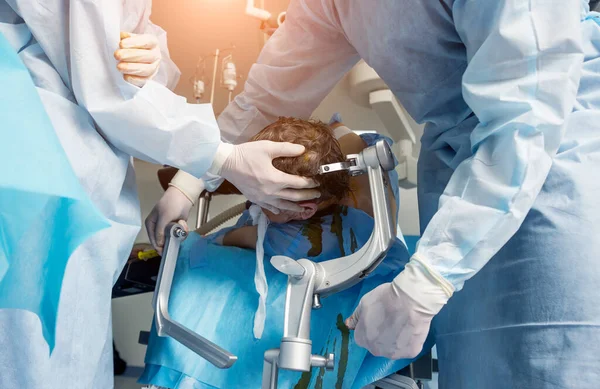 Brain surgery. Group of surgeons in operating room with surgery ...
