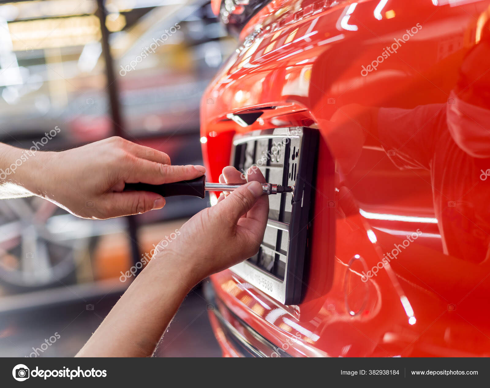 Technician changing car plate number in service center. — Stock Photo ...