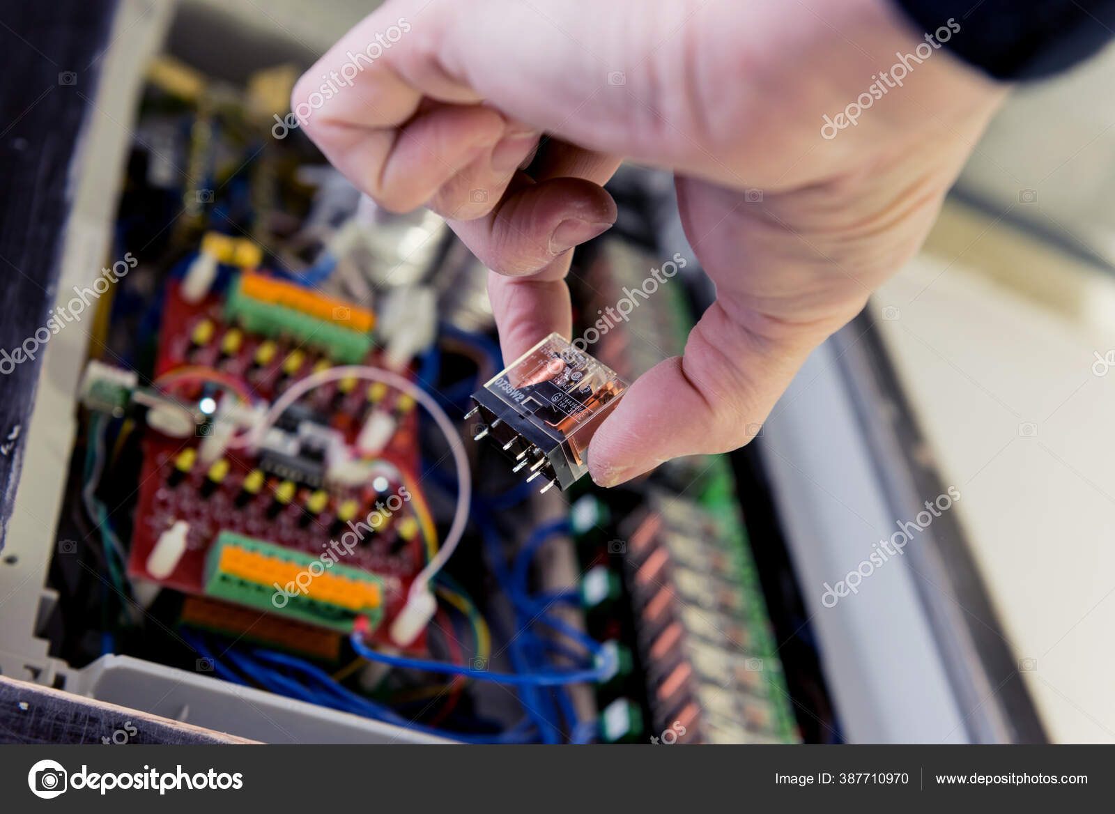 The man is repairing the switchboard voltage with automatic switches ...