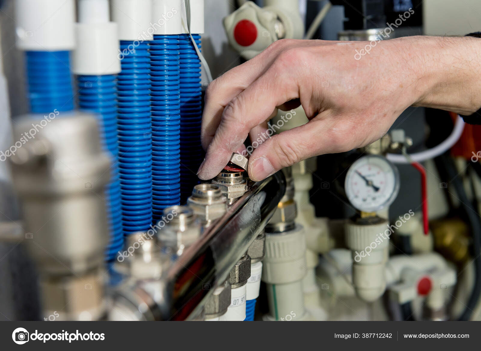 Heating engineer fixing modern heating system in boiler room. — Stock ...