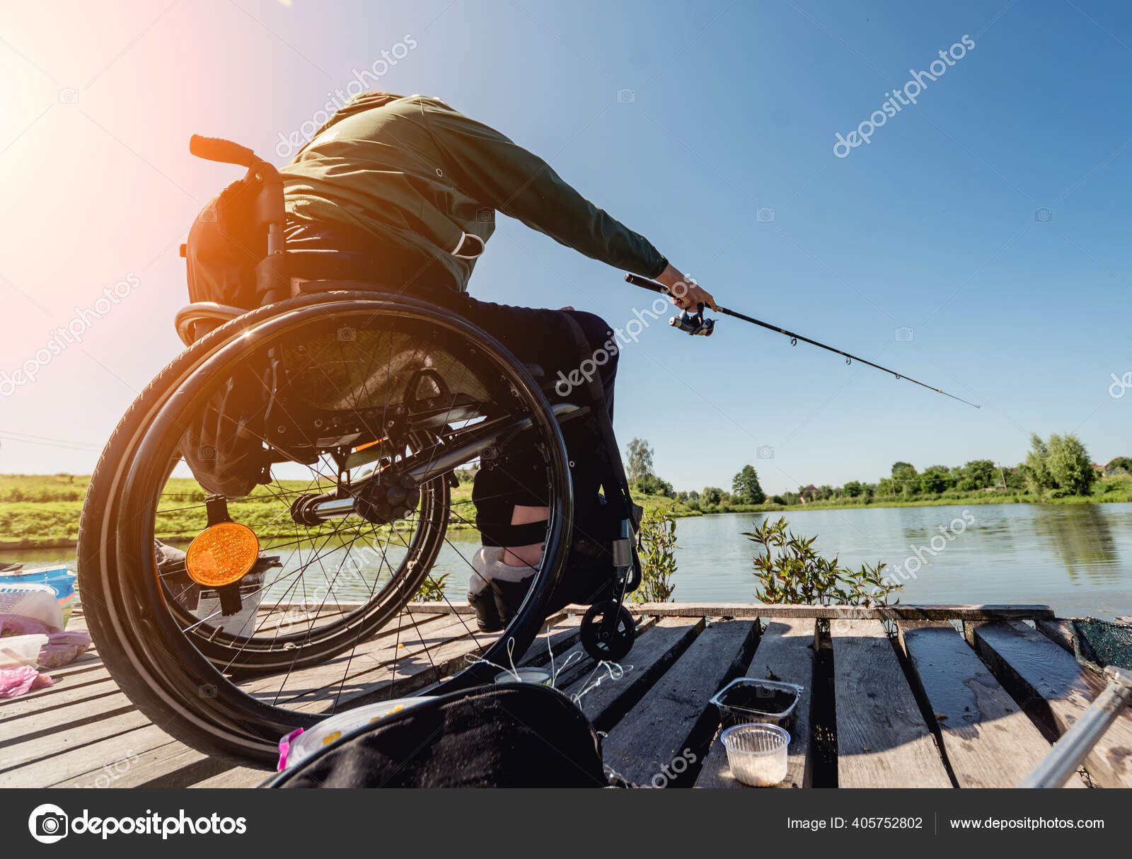 Young disabled man in a wheelchair fishing. — Stock Photo © Romaset ...