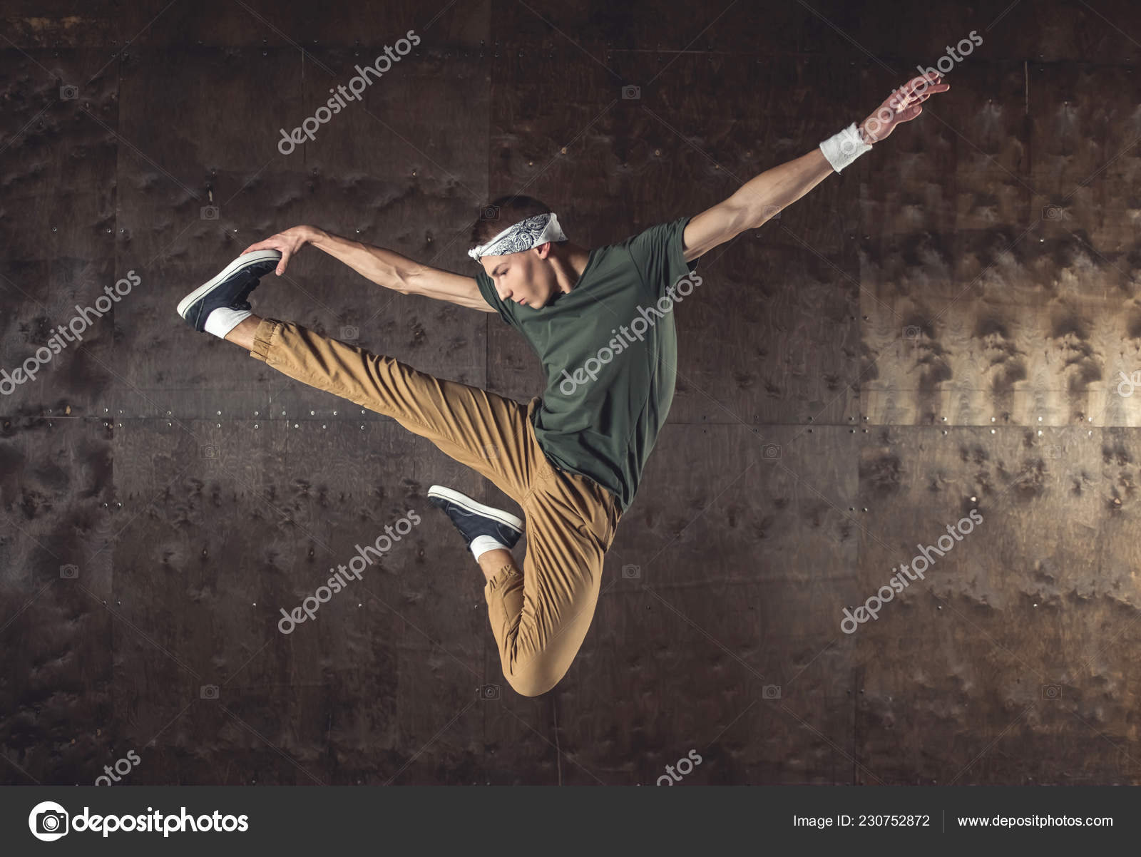 Young Man Break Dancing Wall Background Performing Tricks Stock Photo ...