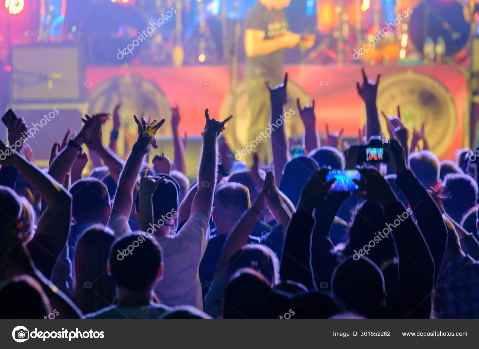 Fans cheering musicians on stage at live rock music concert Stock Photo ...
