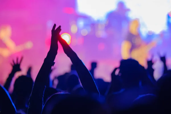 Fans cheering musicians on stage at live rock music concert Stock Photo ...