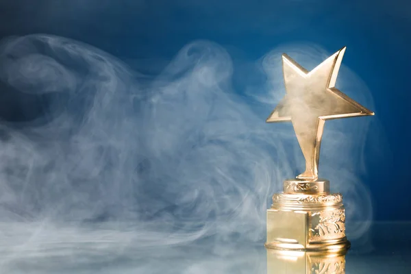 Gold Star Trophy Smoke Blue Background Stock Photo by ©nikkytok 245070490