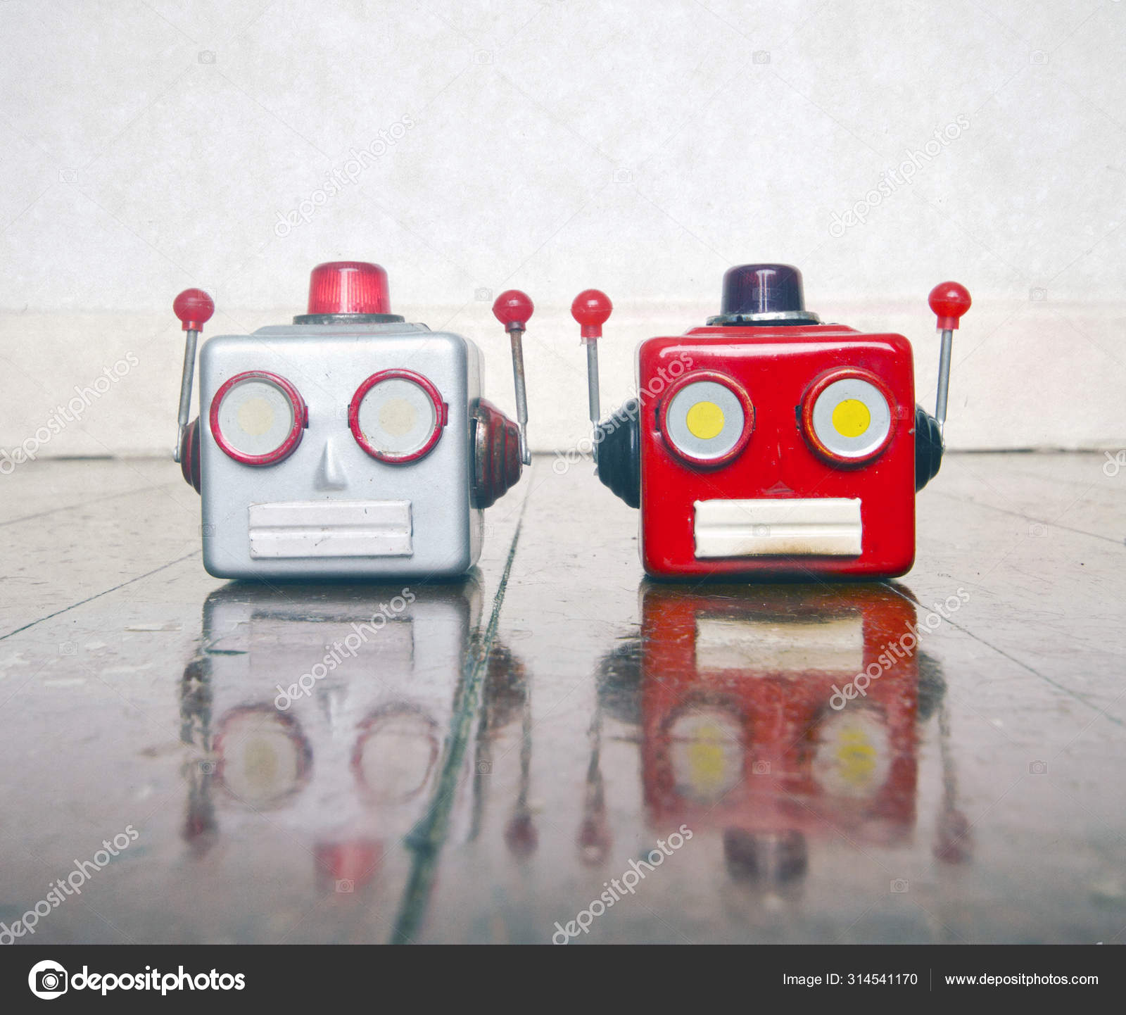 Two metal robot heads chatting on a wooden floor Stock Photo by ...