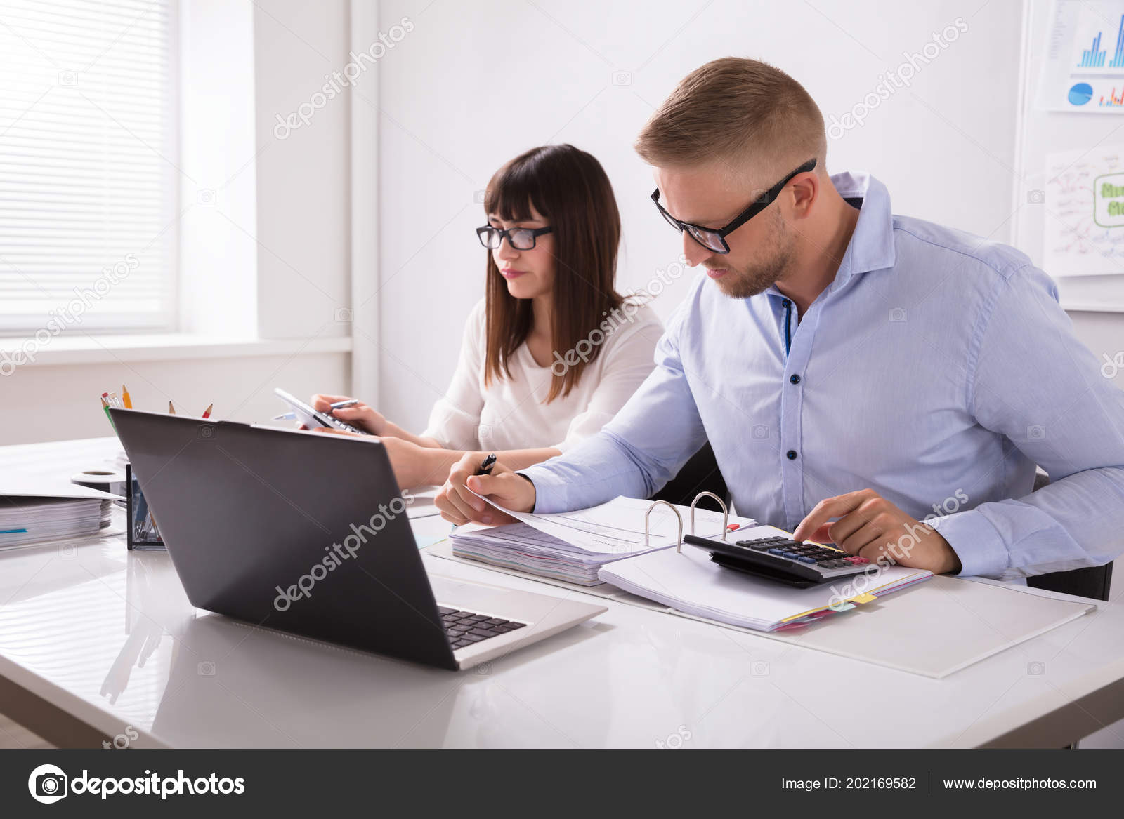 Two Young Businesspeople Calculating Invoice Calculator — Stock Photo ...