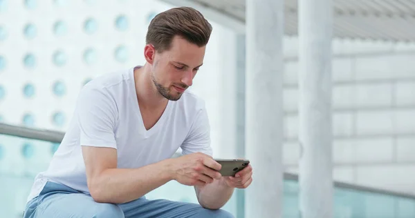 Young man play game on mobile phone - Stock Image - Everypixel