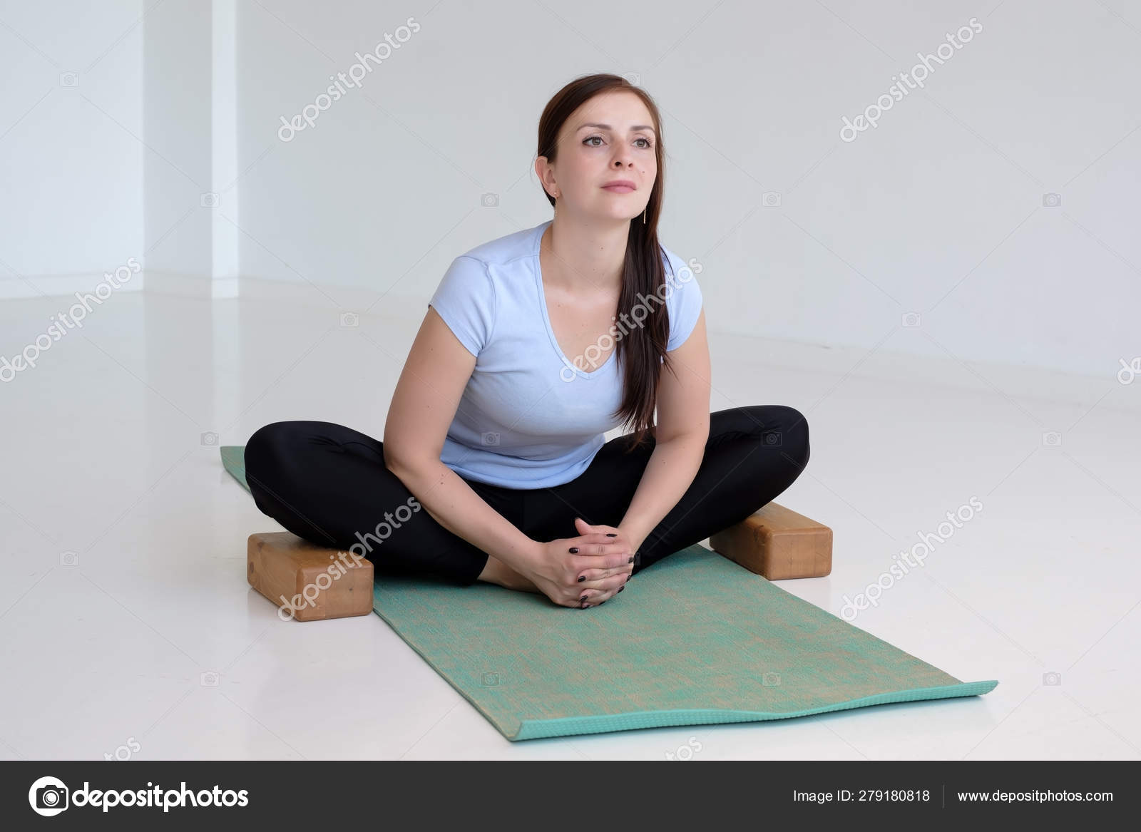 Woman practicing yoga, doing Butterfly exercise, baddha konasana pose ...