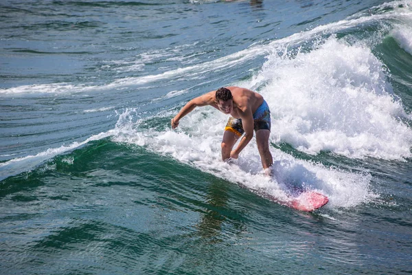 Surfer iding the waves at pacific beach Stock Photo by ©tomasfoto 306250948
