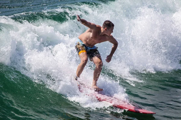 Surfer iding the waves at pacific beach Stock Photo by ©tomasfoto 306250948