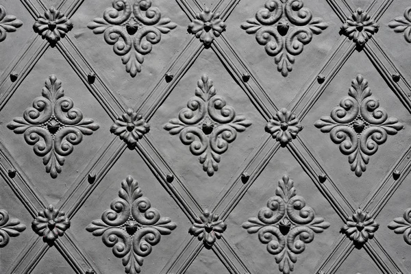 Ancient forged metal texture with decorative overlays. Doors, gates ...