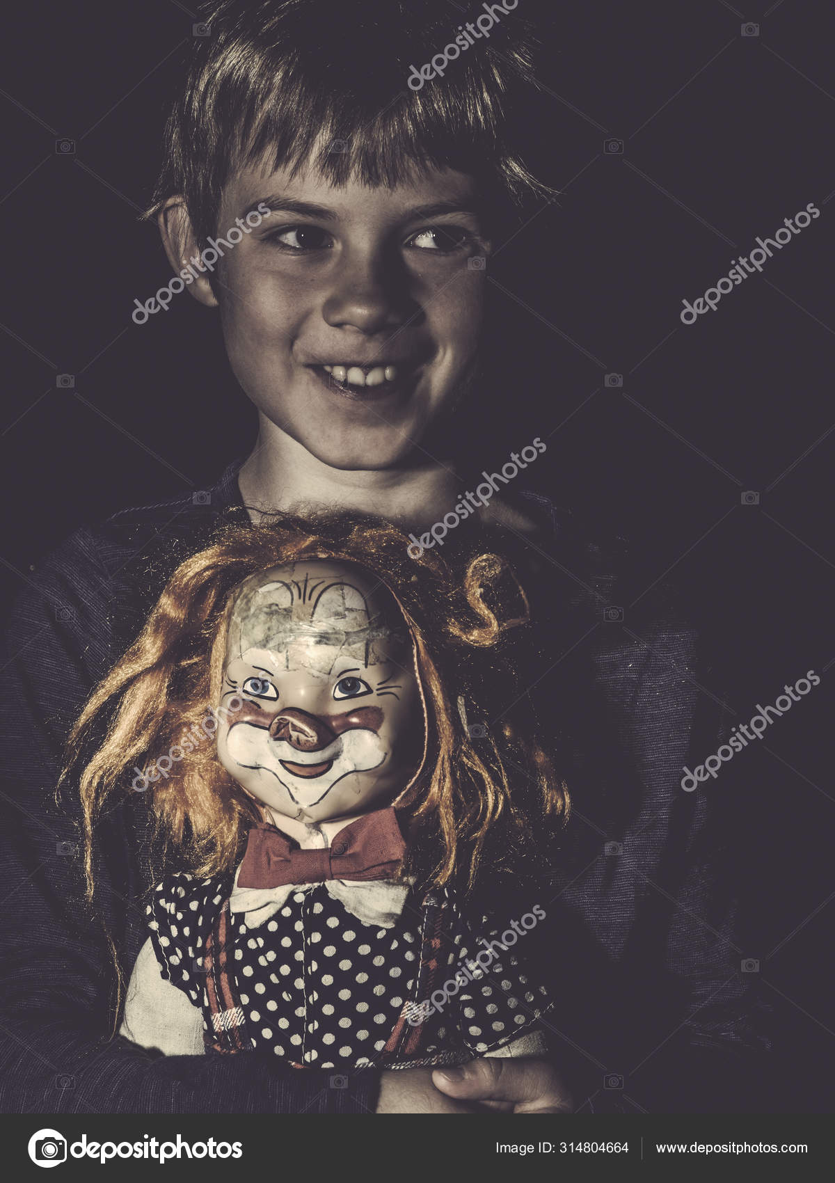 Creepy young boy with scary doll — Stock Photo © sumners #314804664