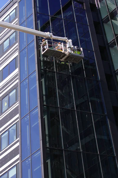 Window cleaners working on a modern high rise glass building - Stock ...