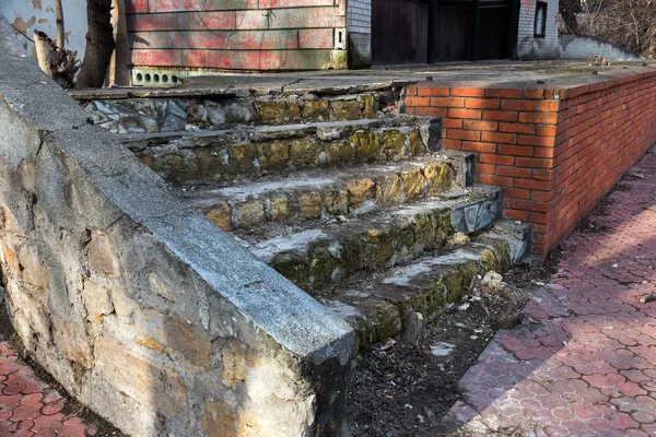 An old open outer stone staircase. Stone, cement steps of the old ...