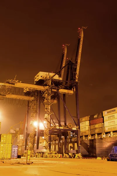 Unloading containers by crane working at container terminals bel Stock ...