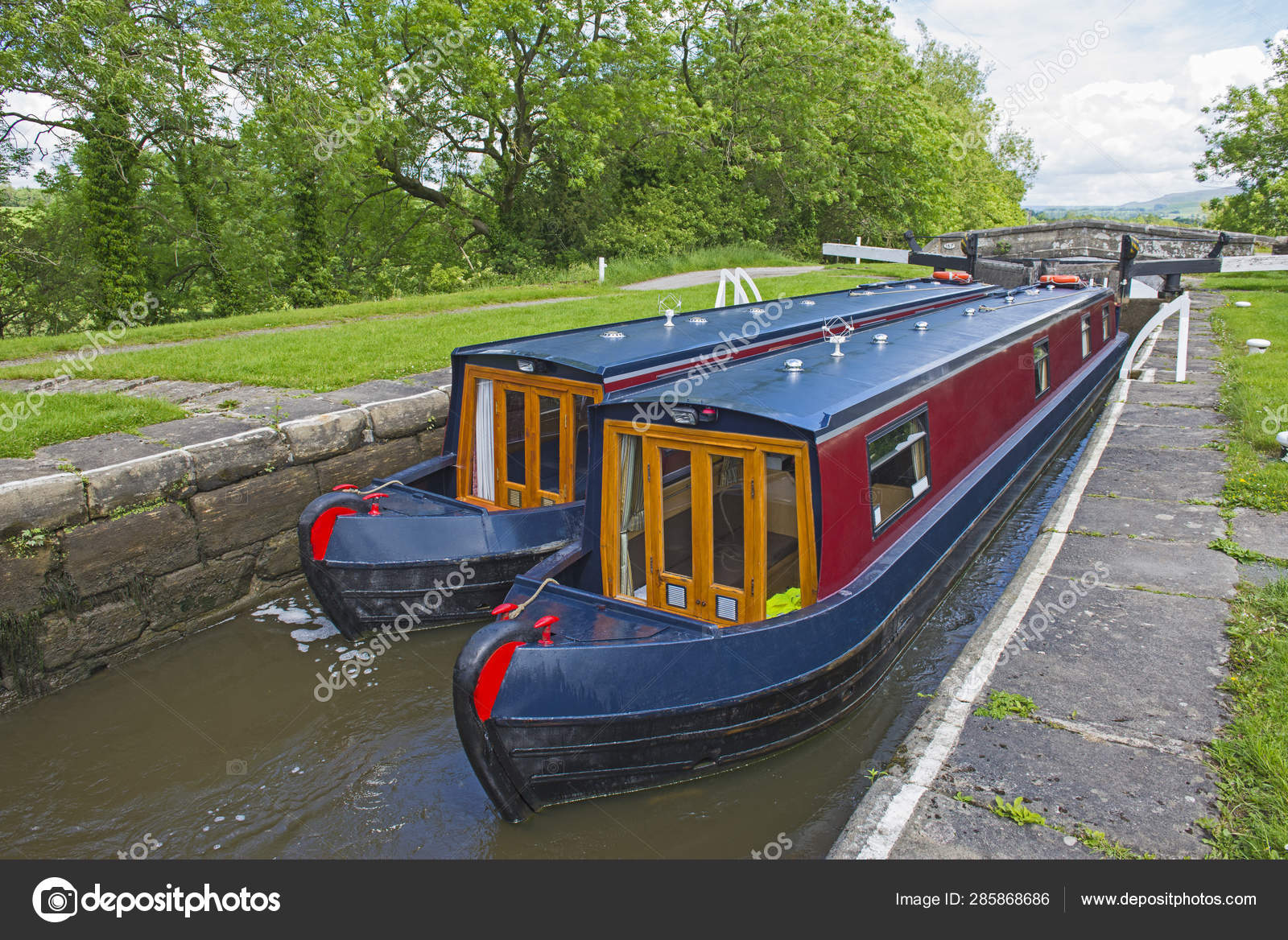 Narrowboats in a lock on a British canal in rural setting Stock Photo ...