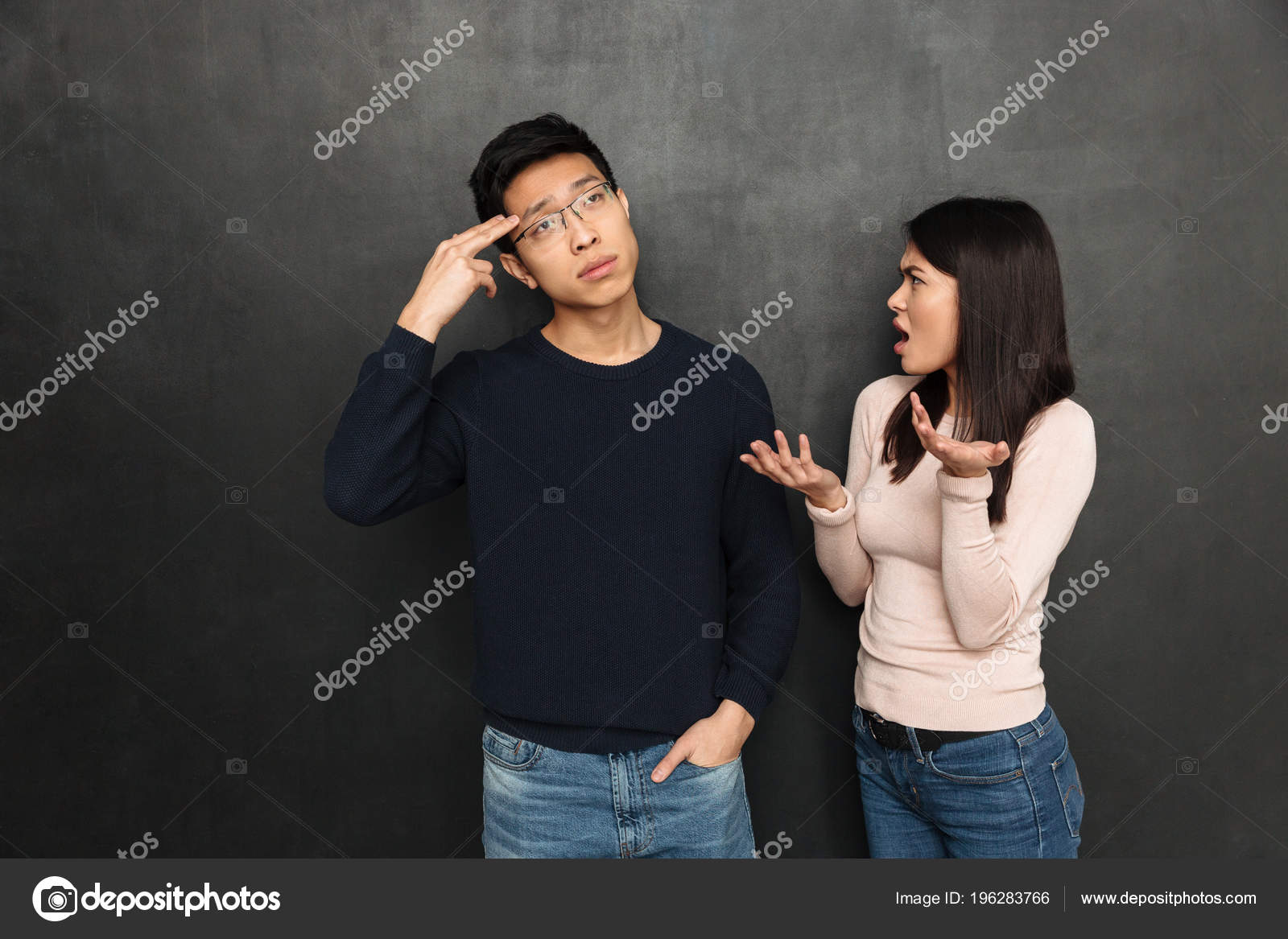 Confused Asian Man Showing Gun Gesture While Listening His Girlfriend ...