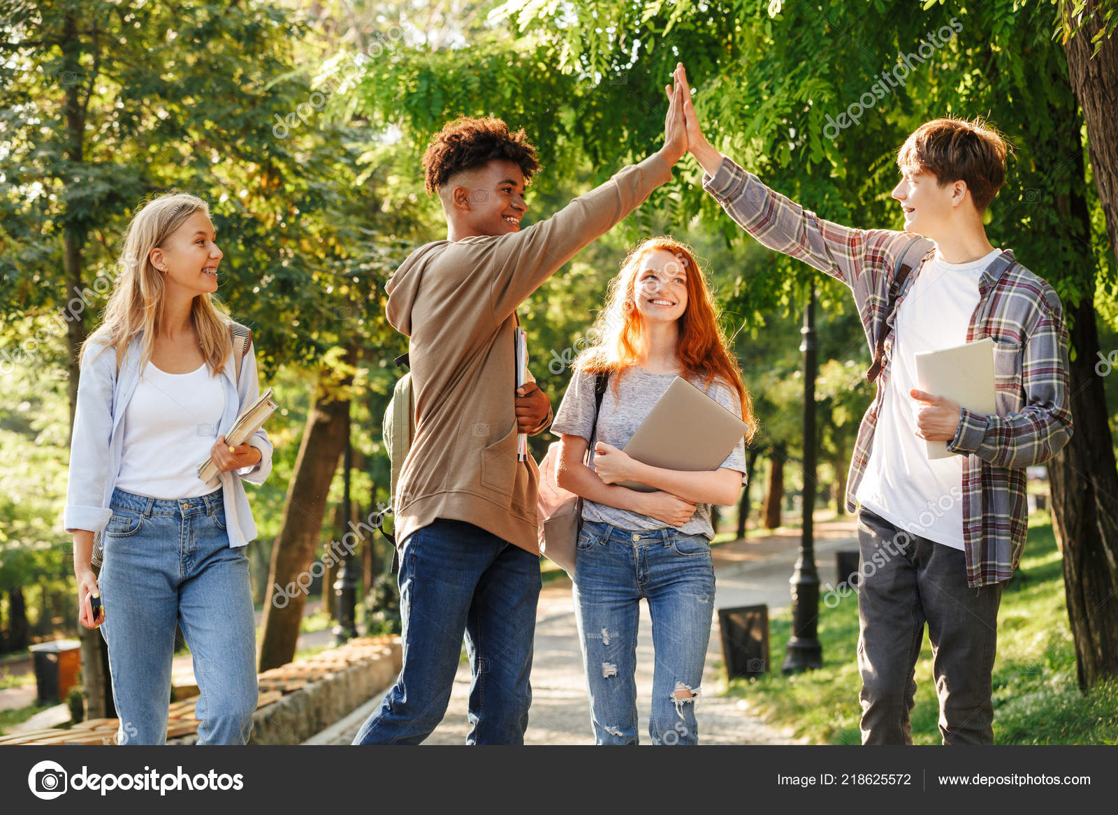 Group Laughing Students Walking Campus Outdoors Giving High Five Stock ...