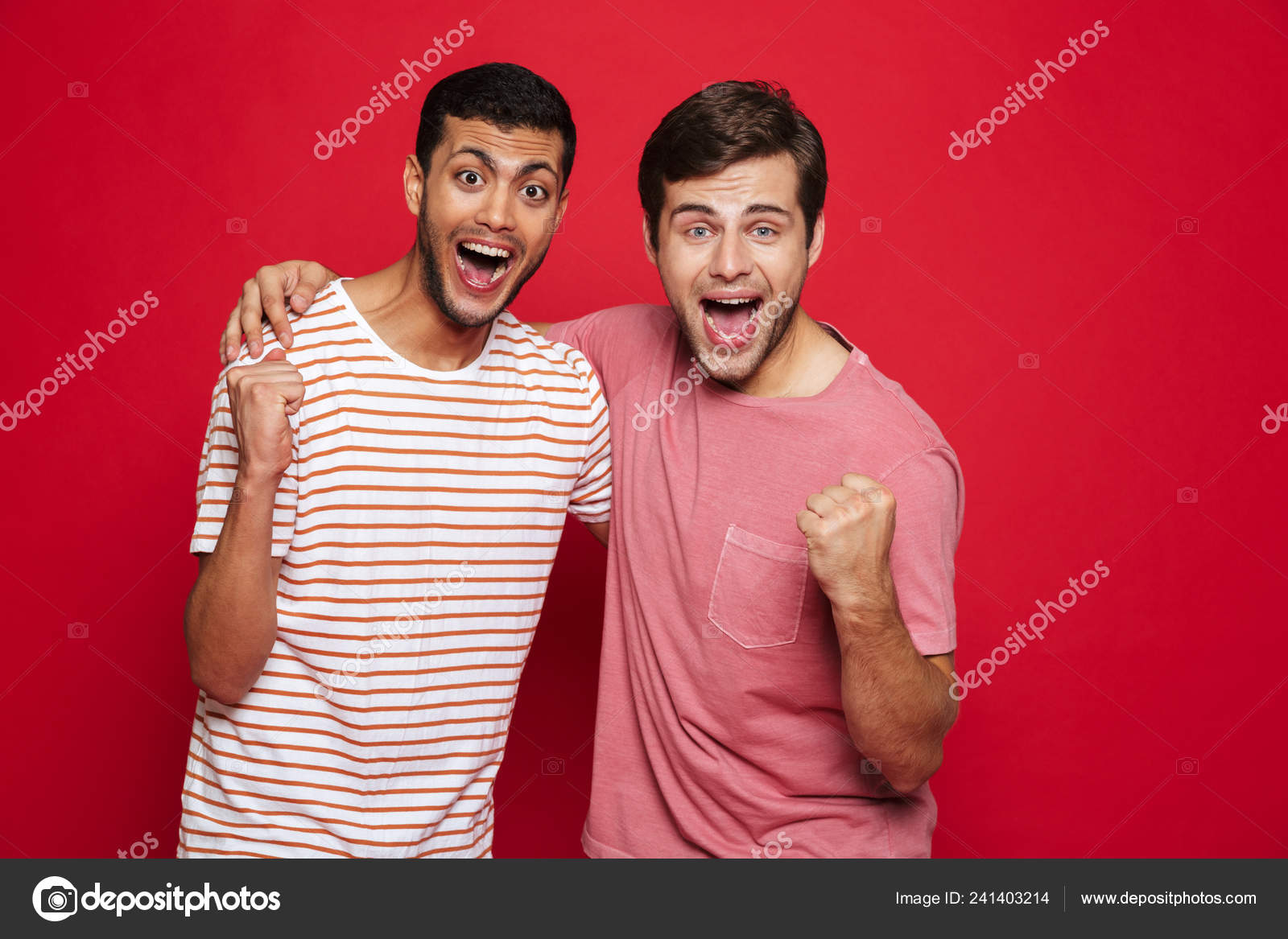 Two Cheerful Young Men Standing Isolated Red Background Celebrating ...