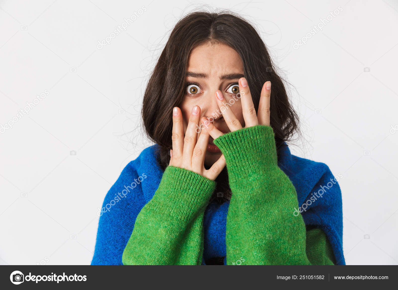 Beautiful confused scared young woman dressed in green sweater posing ...