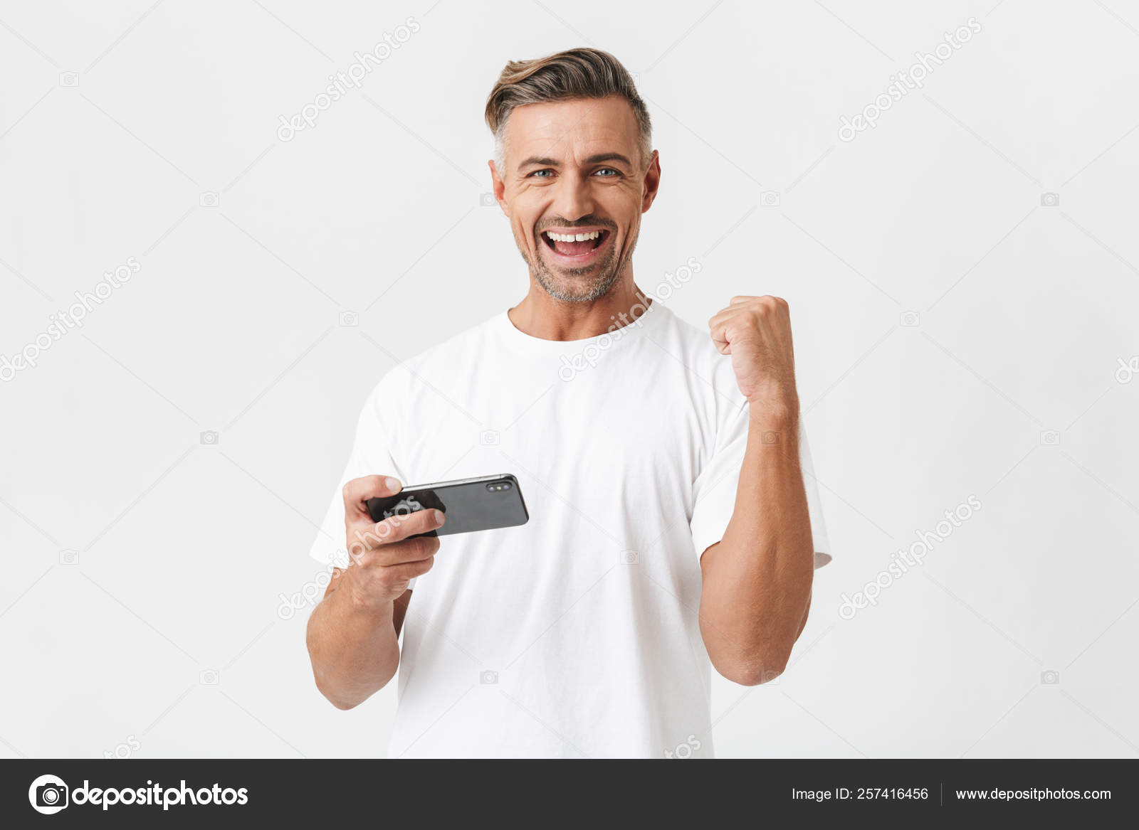 Image of successful man 30s wearing casual t-shirt using smartph ⬇ ...