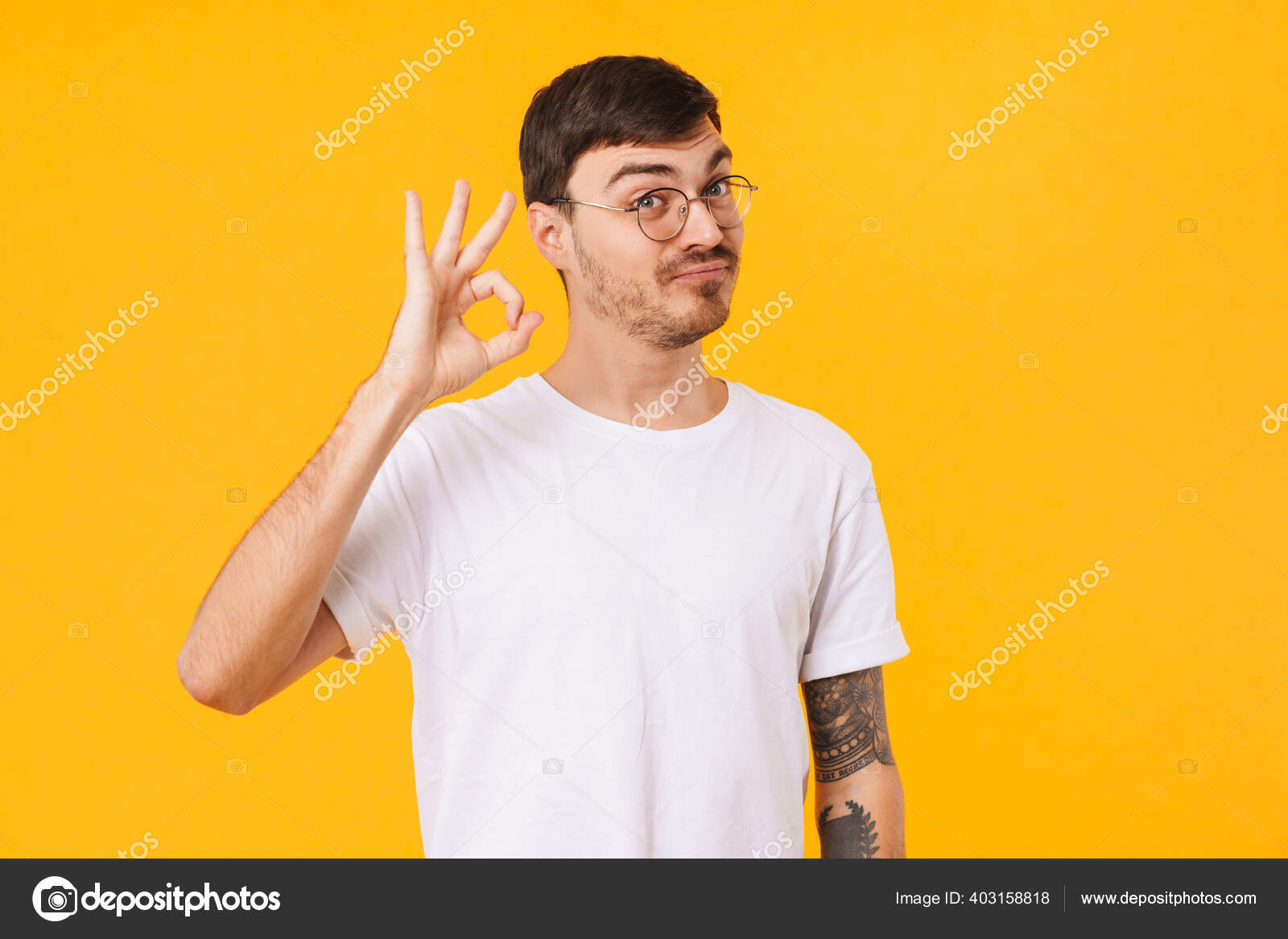 Photo Amusing Young Man Eyeglasses Making Sign Looking Camera Isolated ...