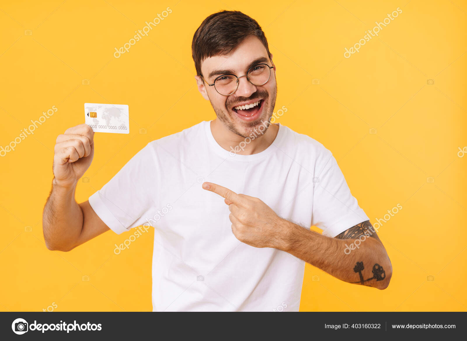 Photo Joyful Young Man Eyeglasses Holding Pointing Finger Credit Card ...