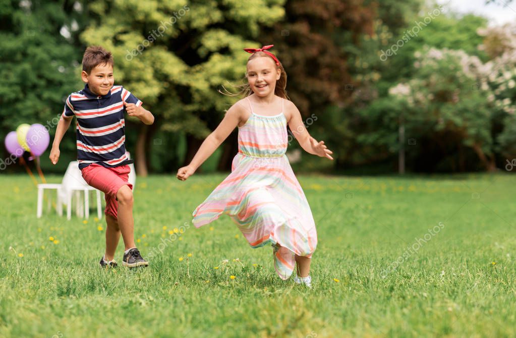 Happy kids playing tag game at birthday party — Stock Photo © Syda ...