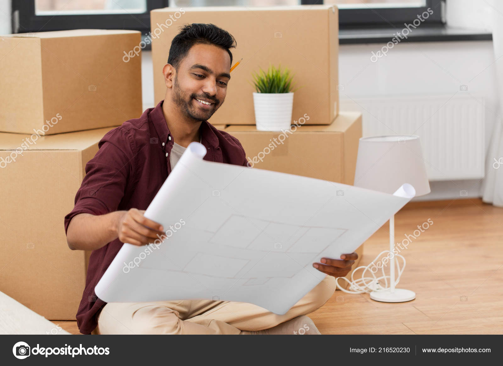 Man with blueprint and boxes moving to new home — Stock Photo © Syda ...
