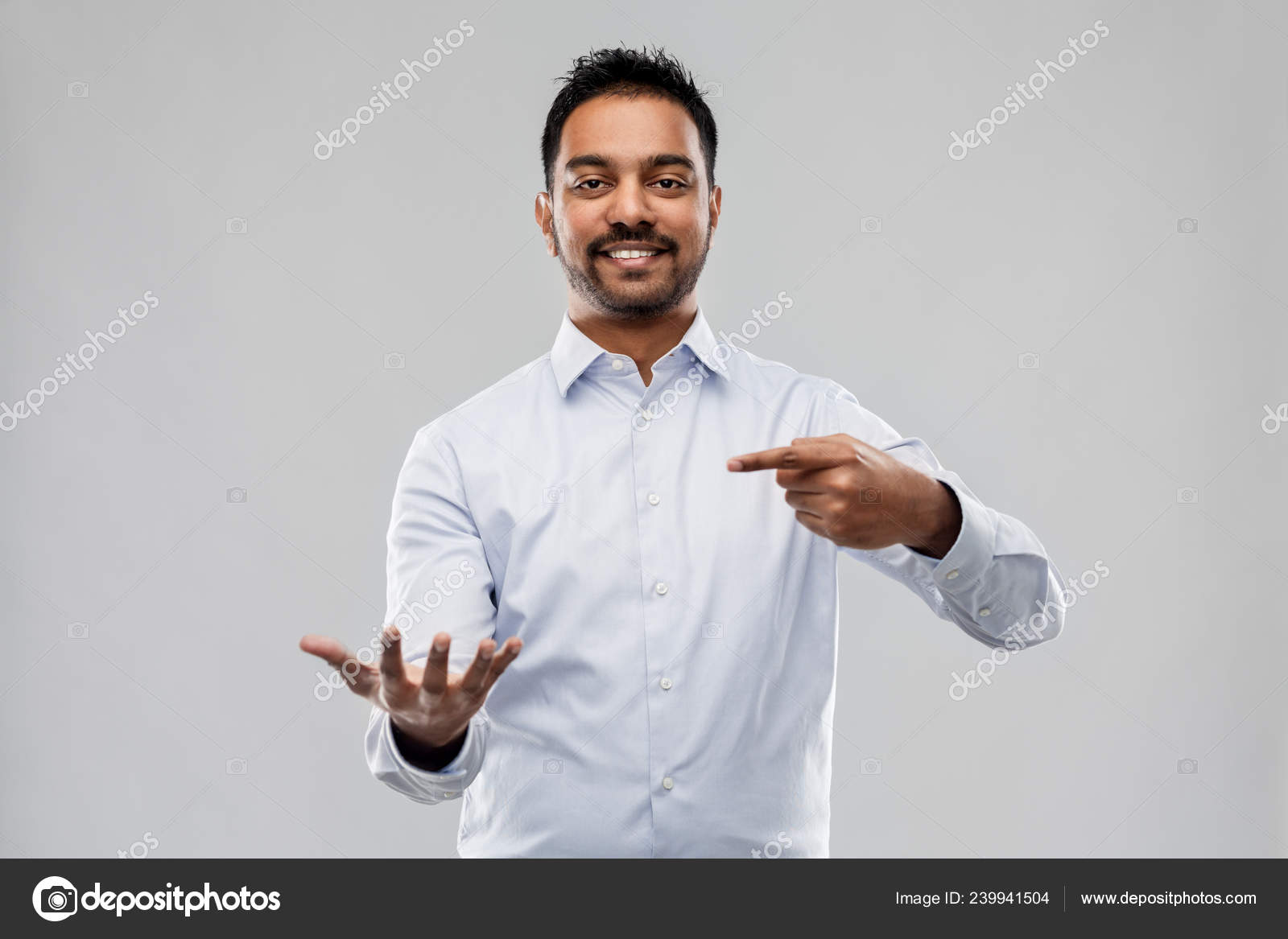 Indian businessman holding something invisible Stock Photo by ©Syda ...