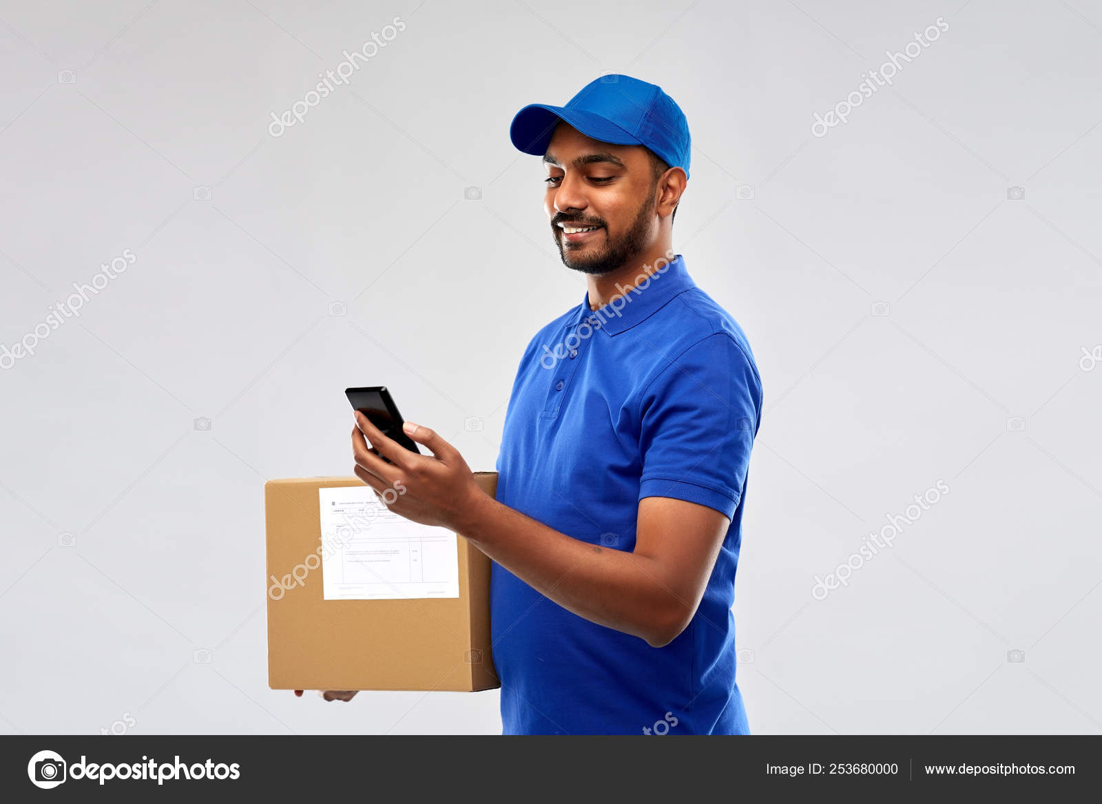 Indian delivery man with smartphone and parcel box — Stock Photo © Syda ...