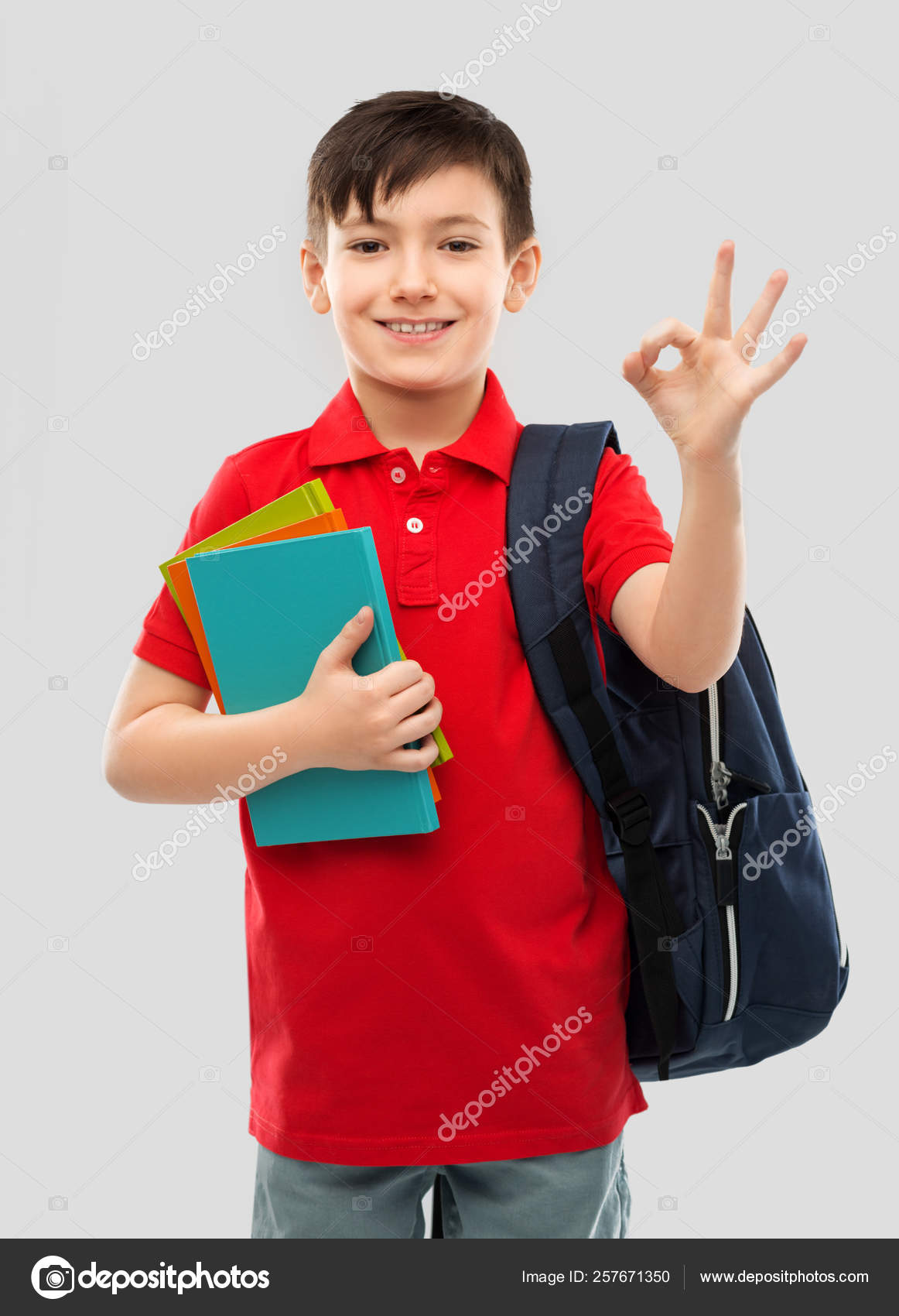 Schoolboy with books and school bag showing ok Stock Photo by ©Syda ...